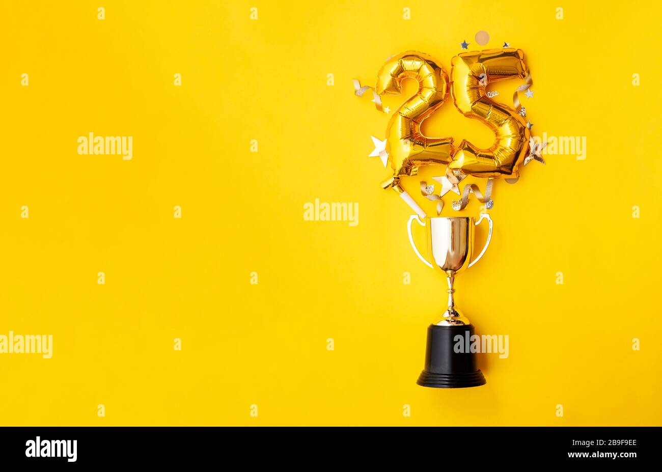 Number 25 gold anniversary celebration balloon exploding from a winning ...