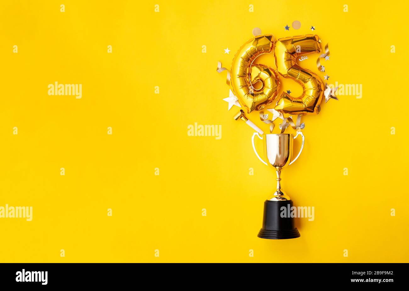 Number 65 gold anniversary celebration balloon exploding from a winning ...