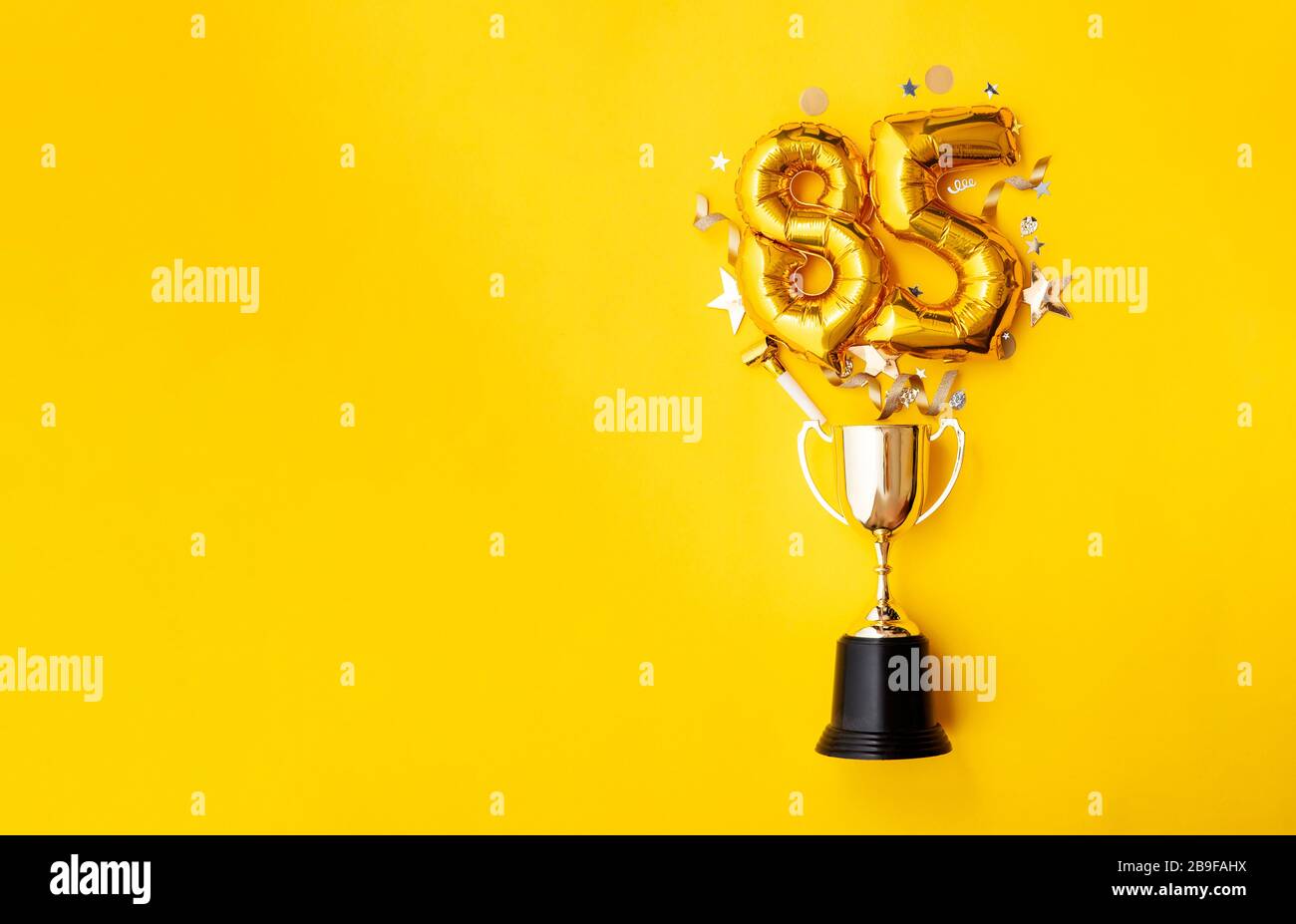 Number 85 gold anniversary celebration balloon exploding from a winning ...