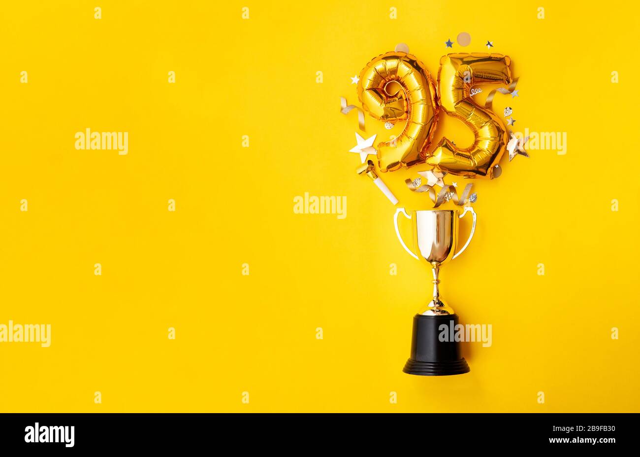 Number 95 gold anniversary celebration balloon exploding from a winning ...