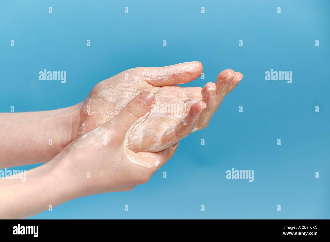 Hand washing Isolated on a blue background Stock Photo - Alamy