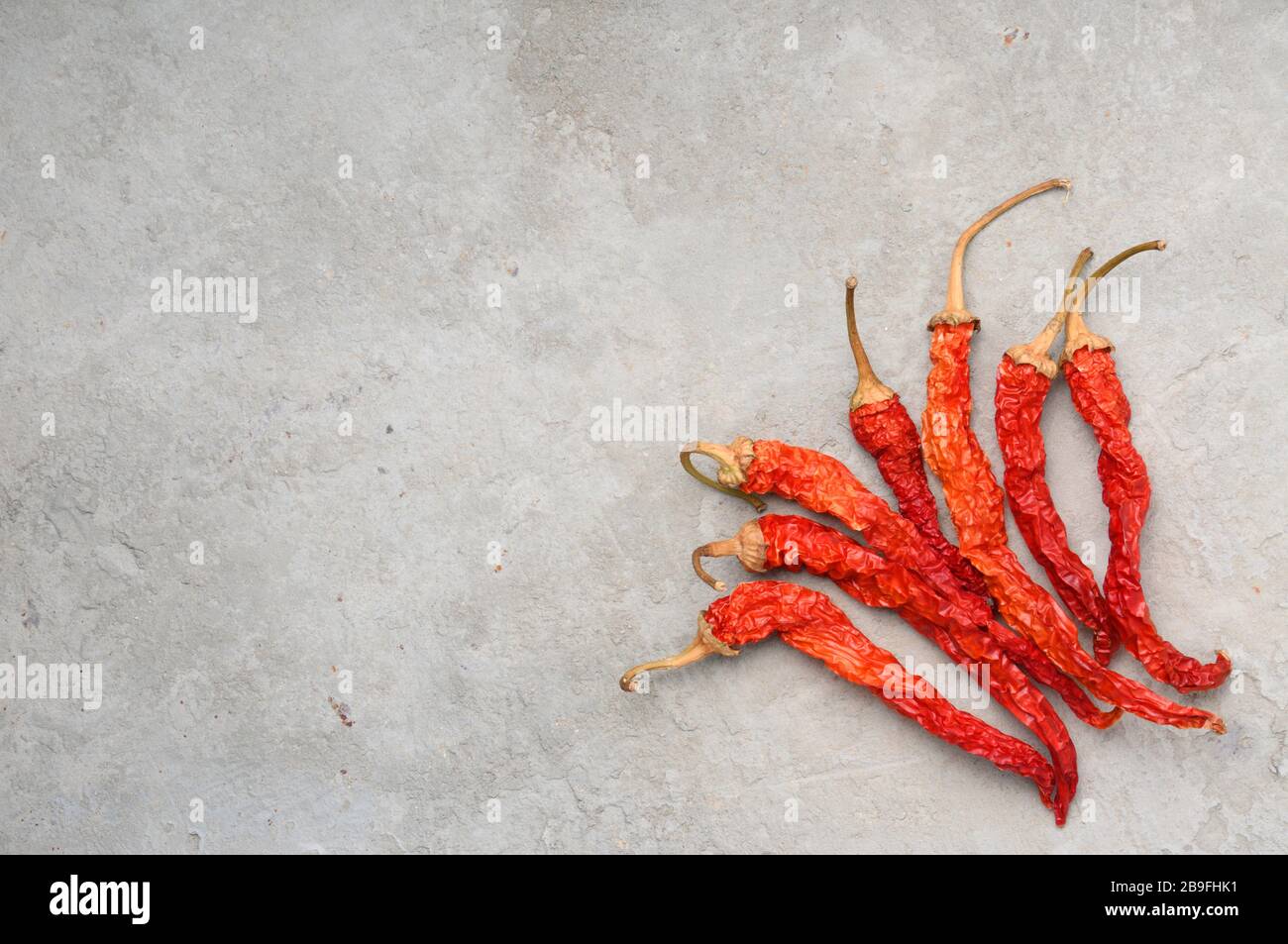 Natural Dried Red Hot Peppers on a Cement Background Stock Photo - Alamy