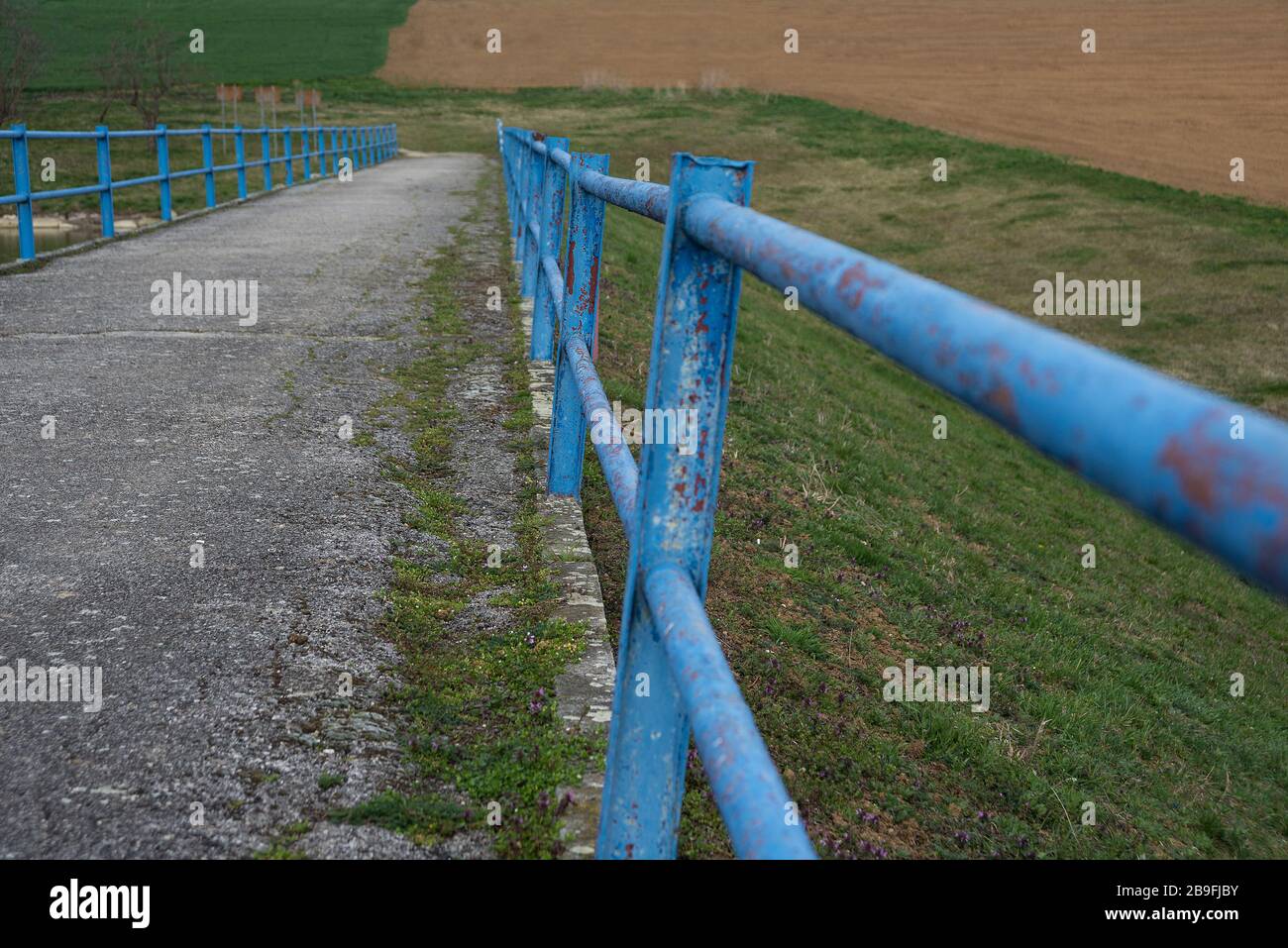 Old blue and yellow rusty handrail outside Stock Photo - Alamy
