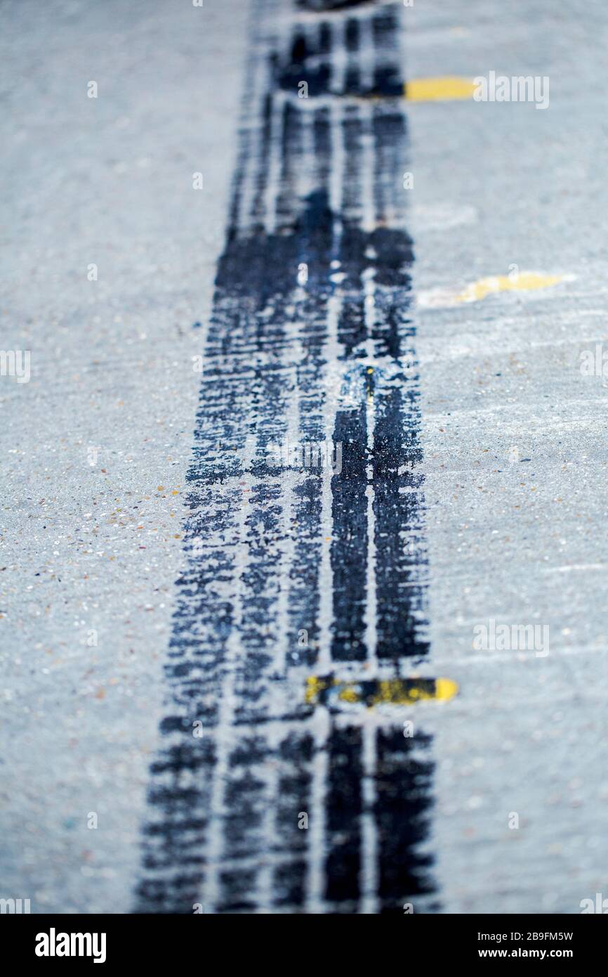 Black tyre marks on a concrete road Stock Photo - Alamy