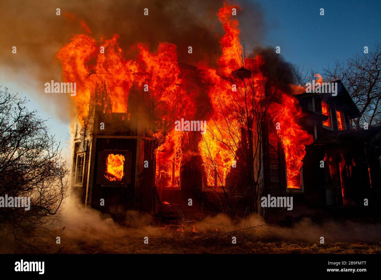 Firefighters trying to save burning house Stock Photo - Alamy