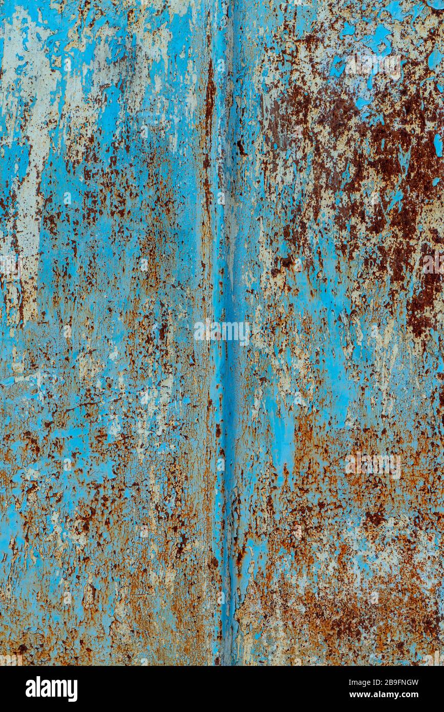 rust and damaged blue and yellow paint on metal sheet. Backgrounds and ...