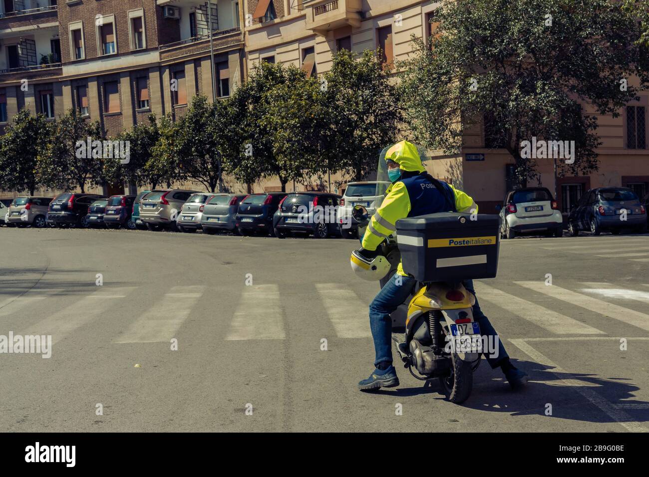 Postman at work (Rome at the time of Covid 19 Stock Photo - Alamy