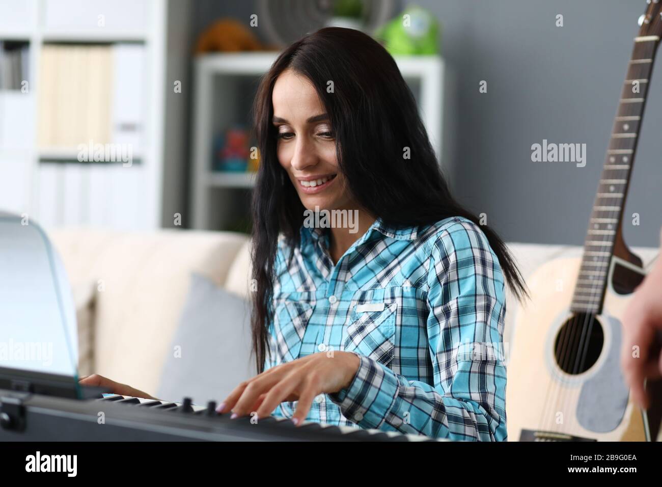 Woman musician playing digital piano hi-res stock photography and ...