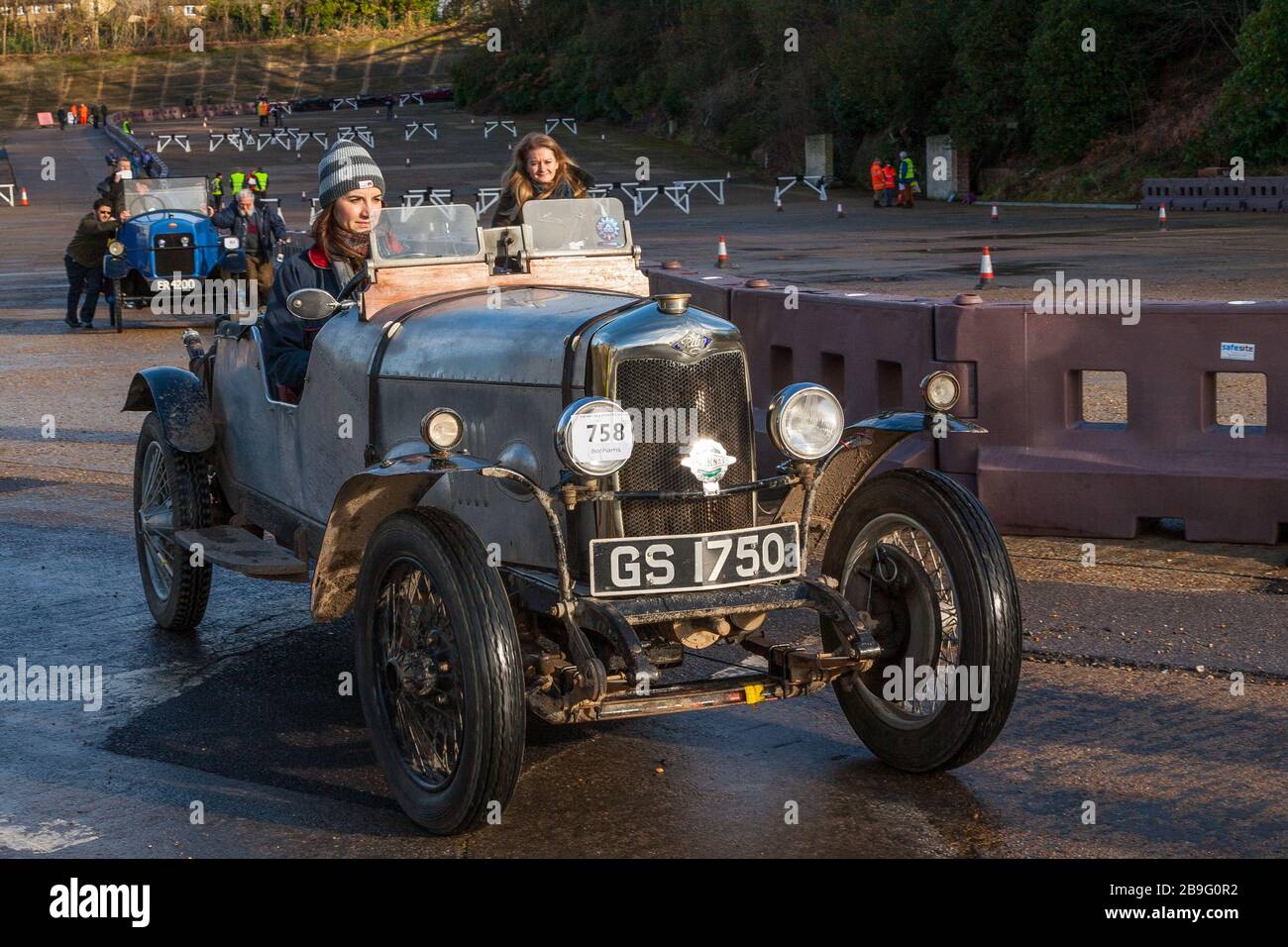 A woman driving a vintage 1929 Riley 9 at the Brooklands VSCC car ...