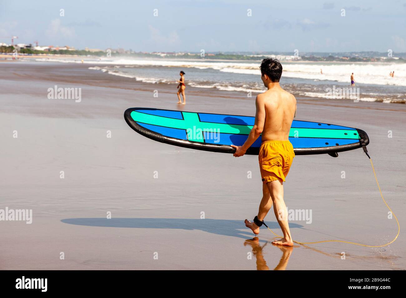 A Surfer With Surfboard On Seminyak Beach, Seminyak, Bali, Indonesia ...