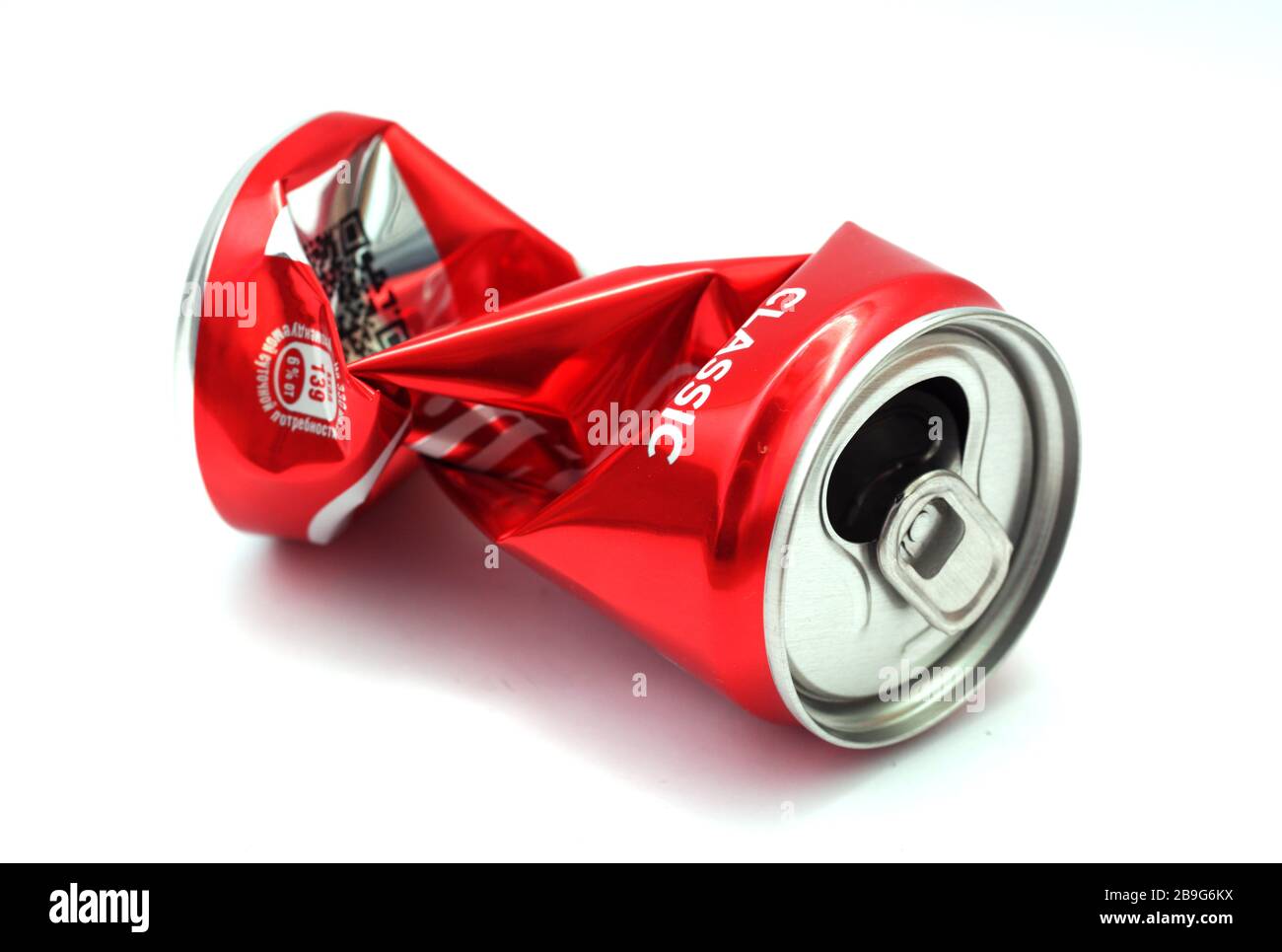 open crumpled aluminum can of carbonated drink, white background, clos ...