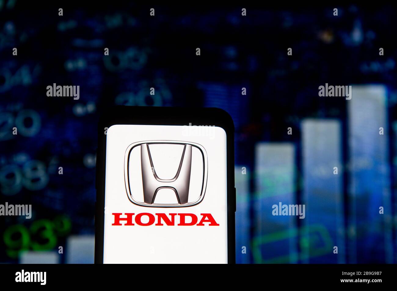 In this photo illustration a Honda logo seen displayed on a smartphone ...