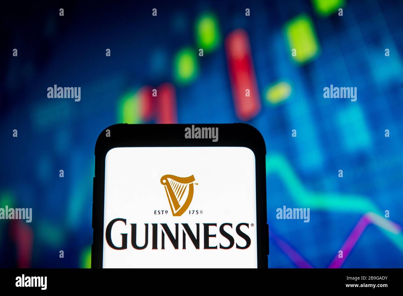 In this photo illustration a Guiness logo seen displayed on a ...