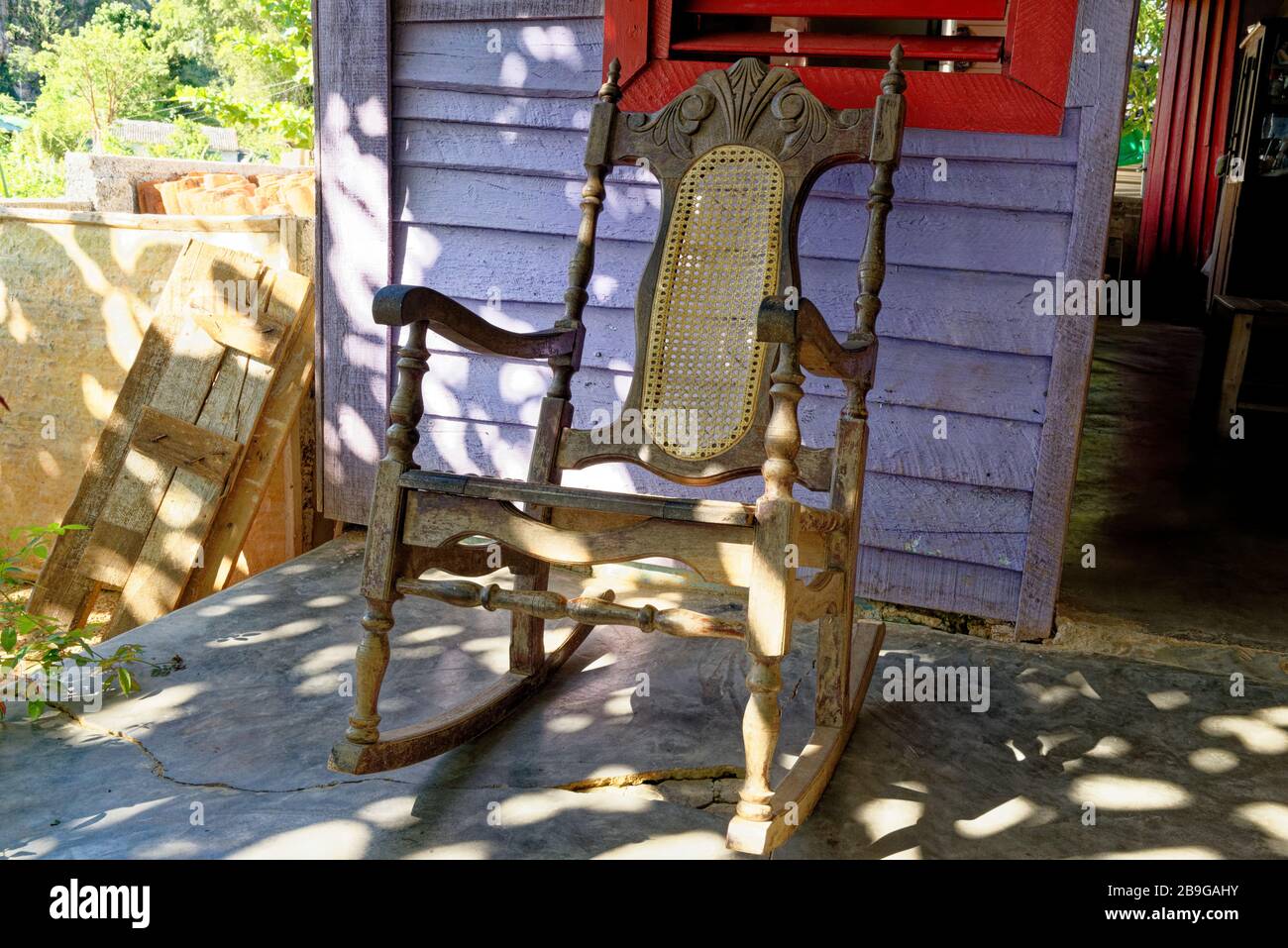 Vintage cuban rocking chair in front of a typical old house in Vinales ...