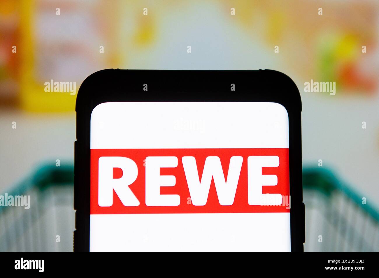 In this photo illustration a REWE logo seen displayed on a smartphone ...