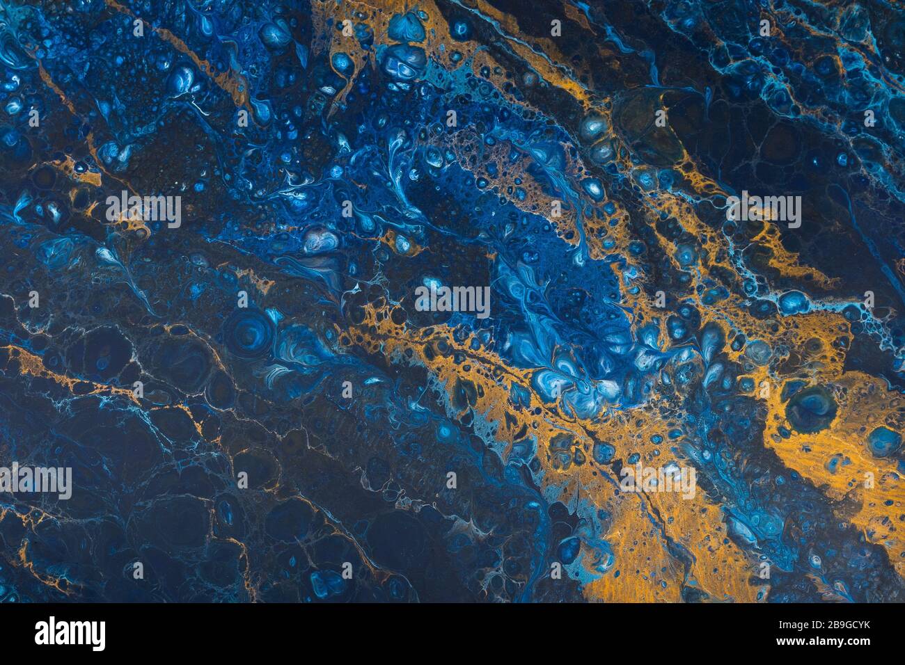 Blue metallic paint patterns in water hi-res stock photography and ...