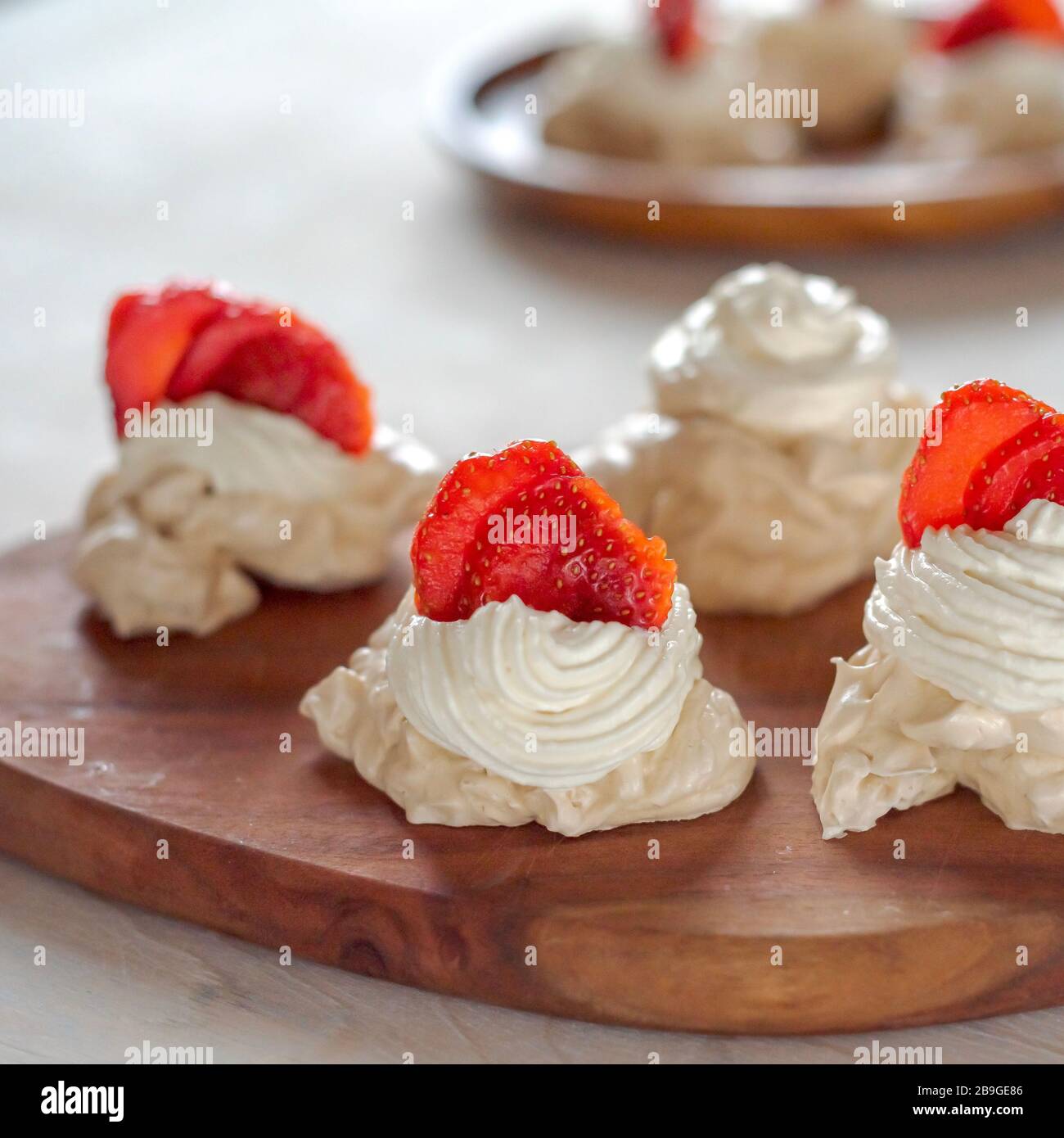 the process of creating Pavlova dessert, decorating the meringue Stock ...