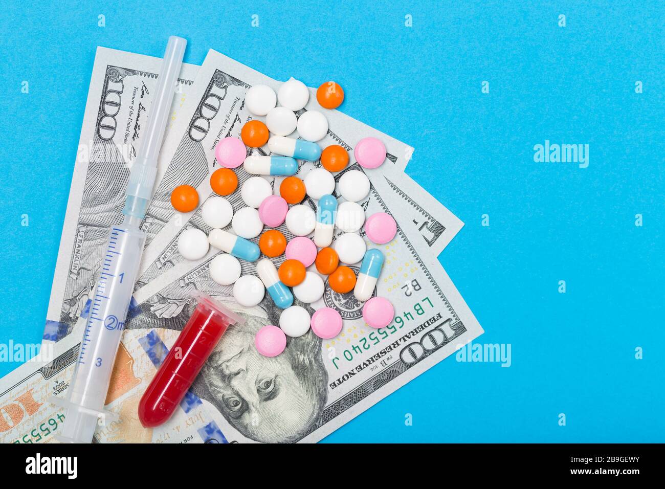 Medicine pills, syringe, blood test tube, tablets and capsules on US ...