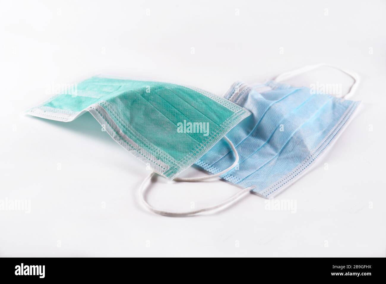 Two surgical breathing masks green and blue (frog eye view on white ...