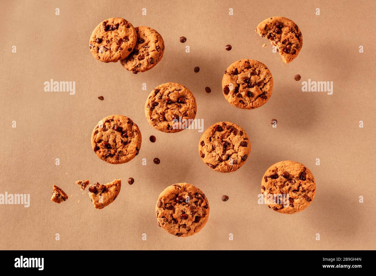 Chocolate chip cookies, flying on a brown paper background, shot from ...