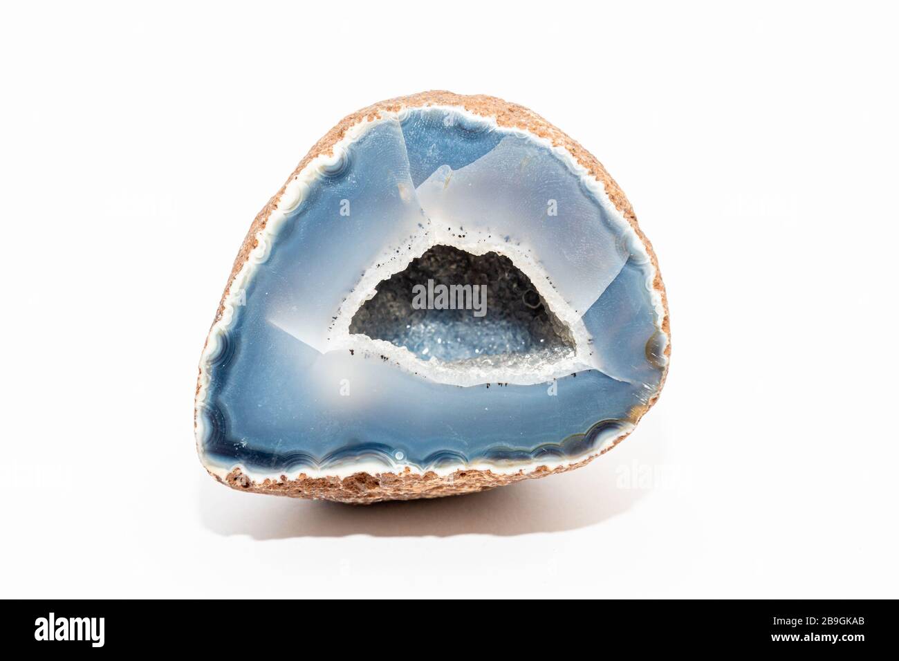 Blue colored geode outside looking like usual rock inside full of tiny ...