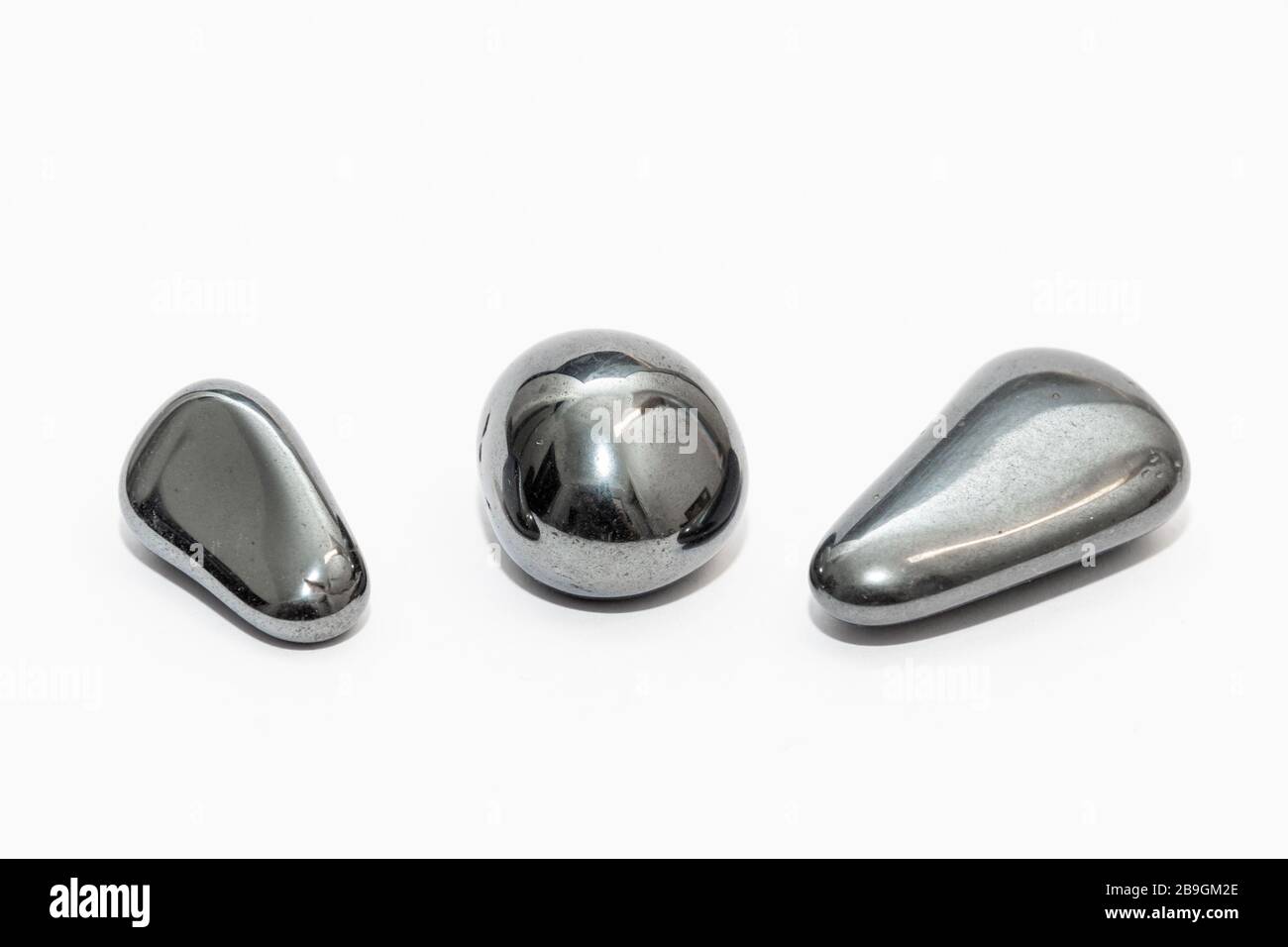 Three metallic looking round and highly polished rare gems Stock Photo ...