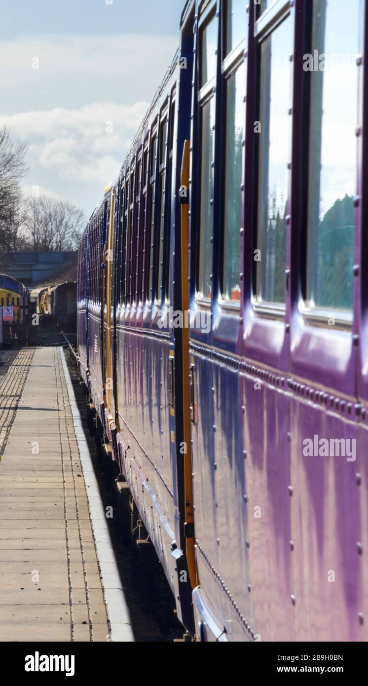 View looking down the side of class 142 pacer trains 142060 + 142028 ...