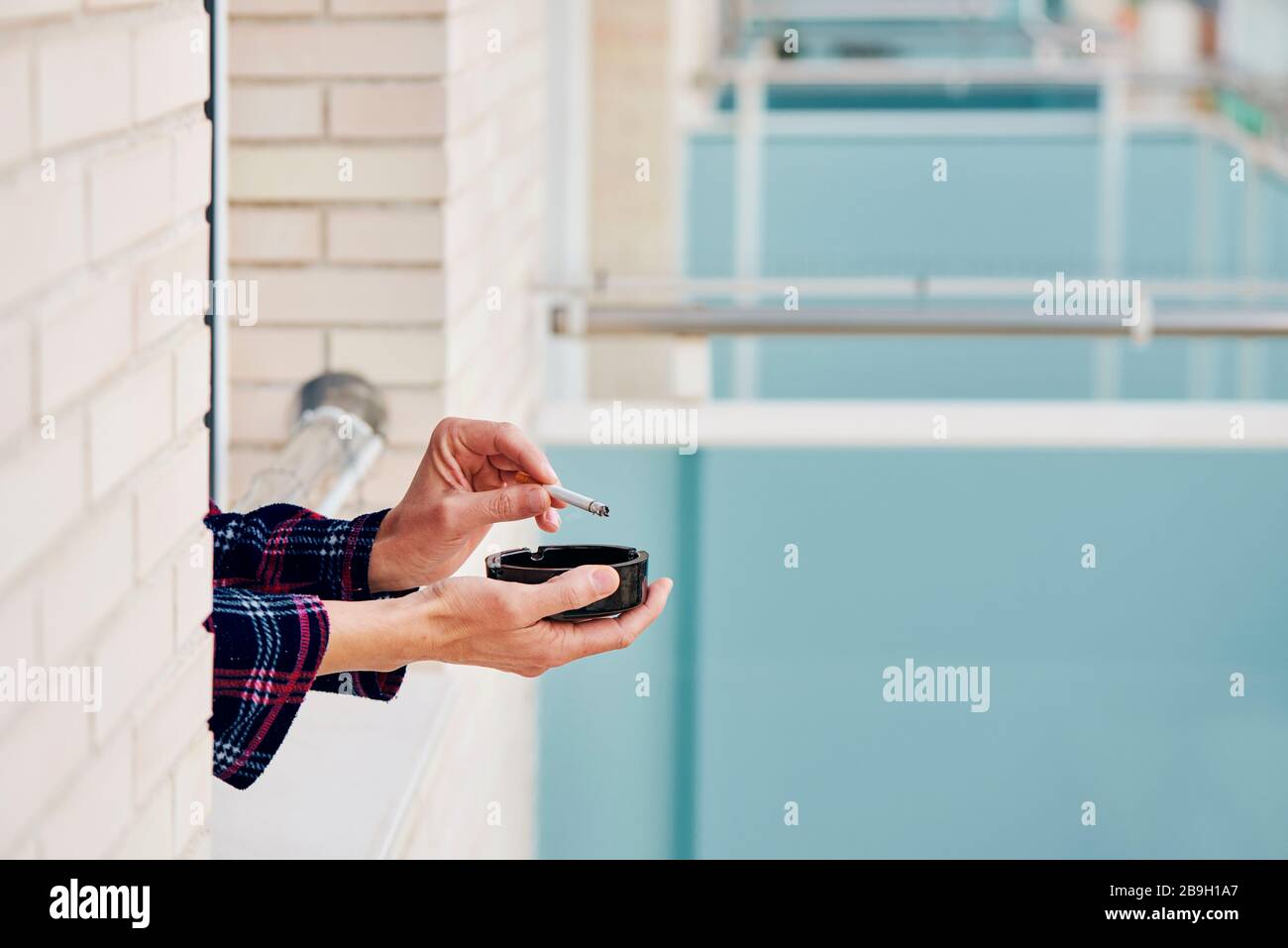 closeup of a young caucasian man, in pajamas, smoking a cigarette ...
