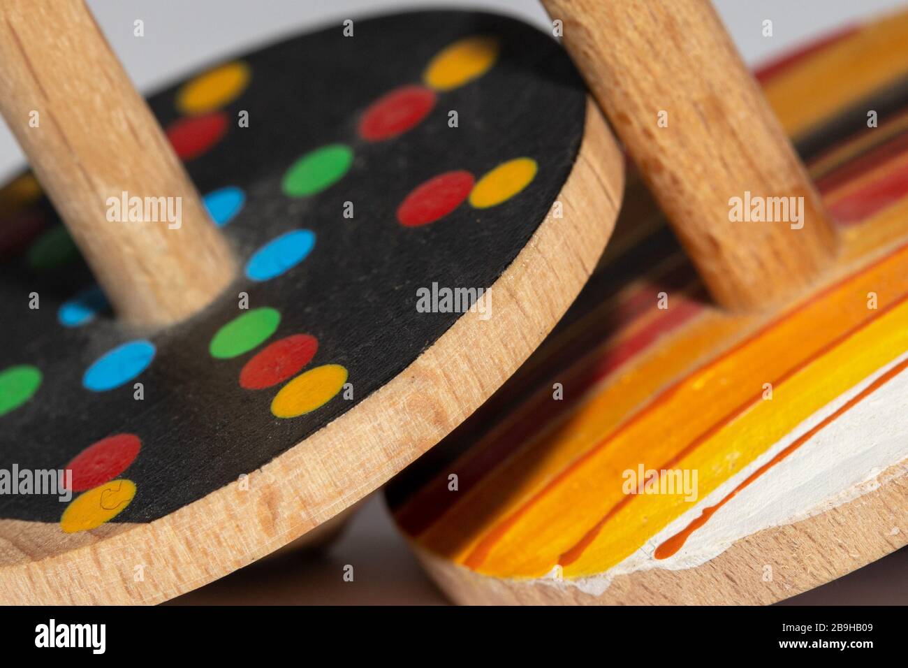 close up of a wooden spinner tops, typical toy for children isolated on ...