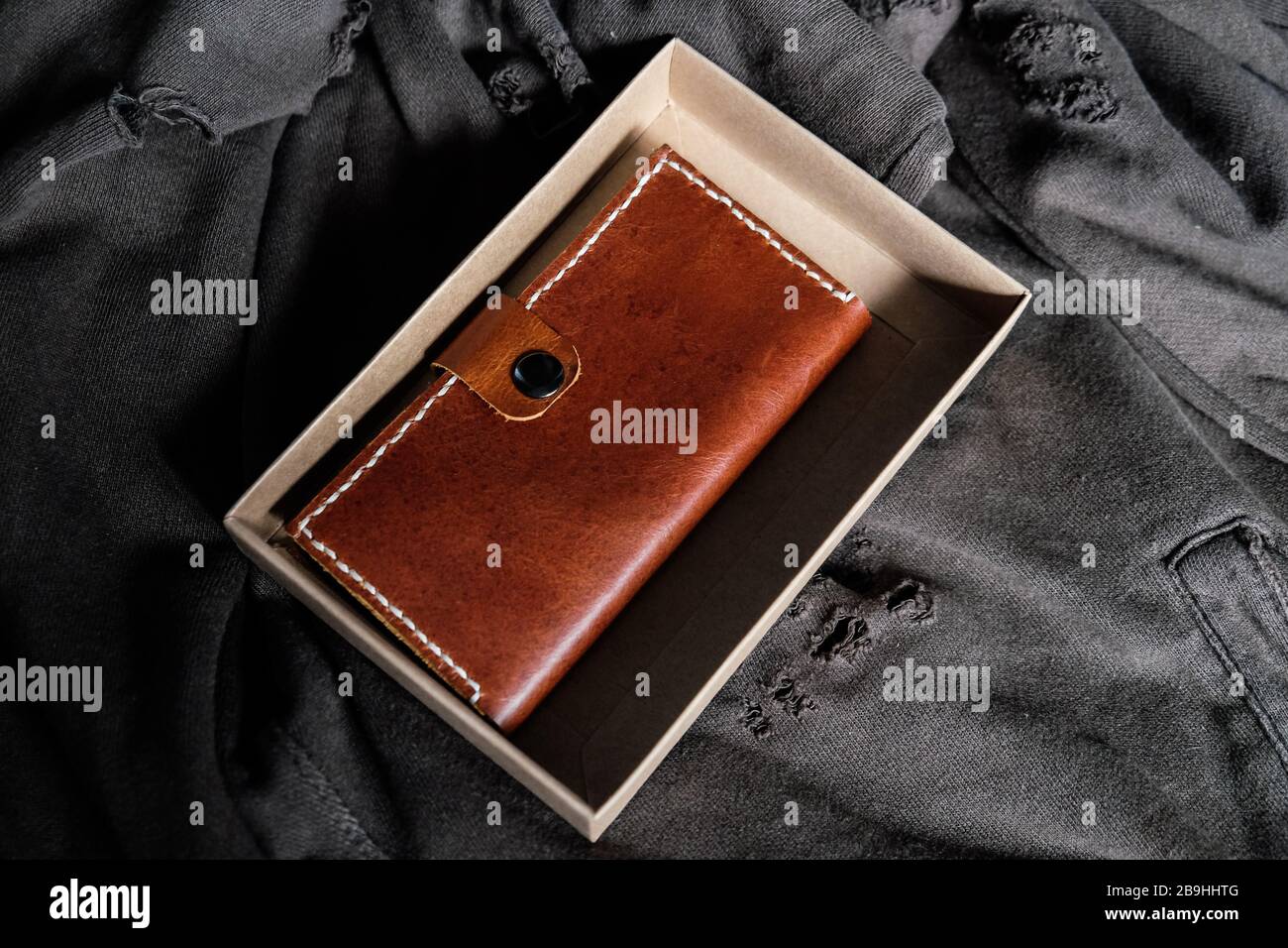 Genuine smartphone case with wallet handmade in paper box on vintage ...