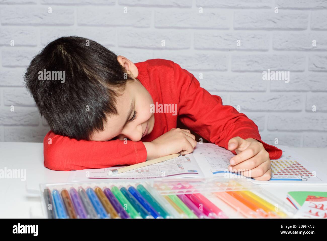 Upset boring schoolboy doing homework. Education, school, learning ...