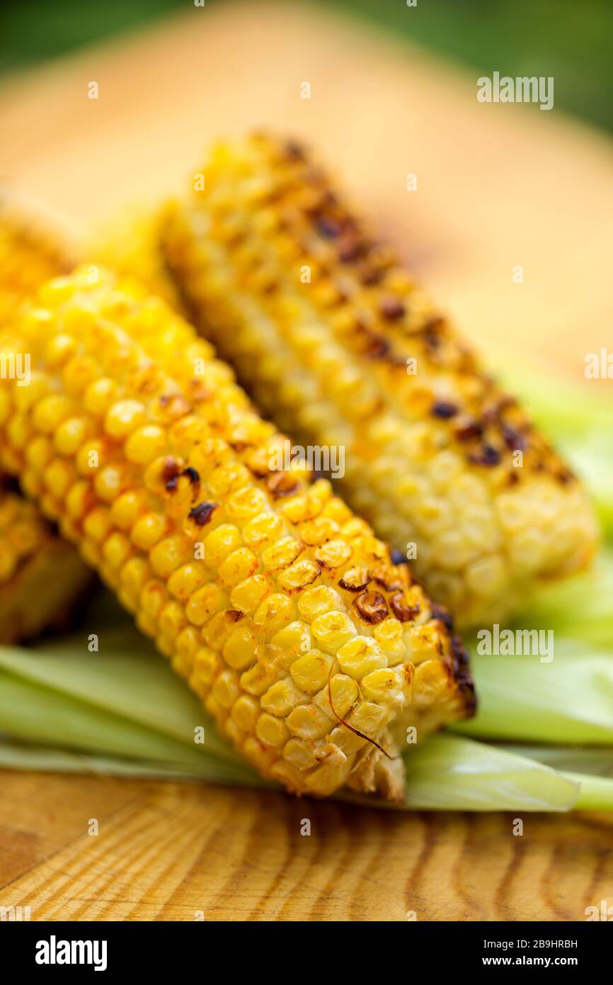 Grilled sweet corn cobs on rustic wood Stock Photo - Alamy