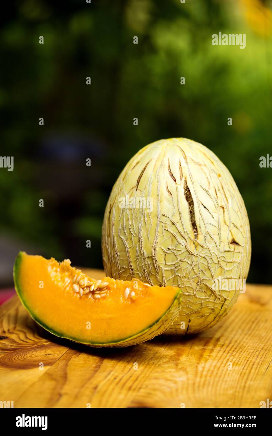 Ripe sweet sliced heirloom melon on rustic wood in a garden Stock Photo ...