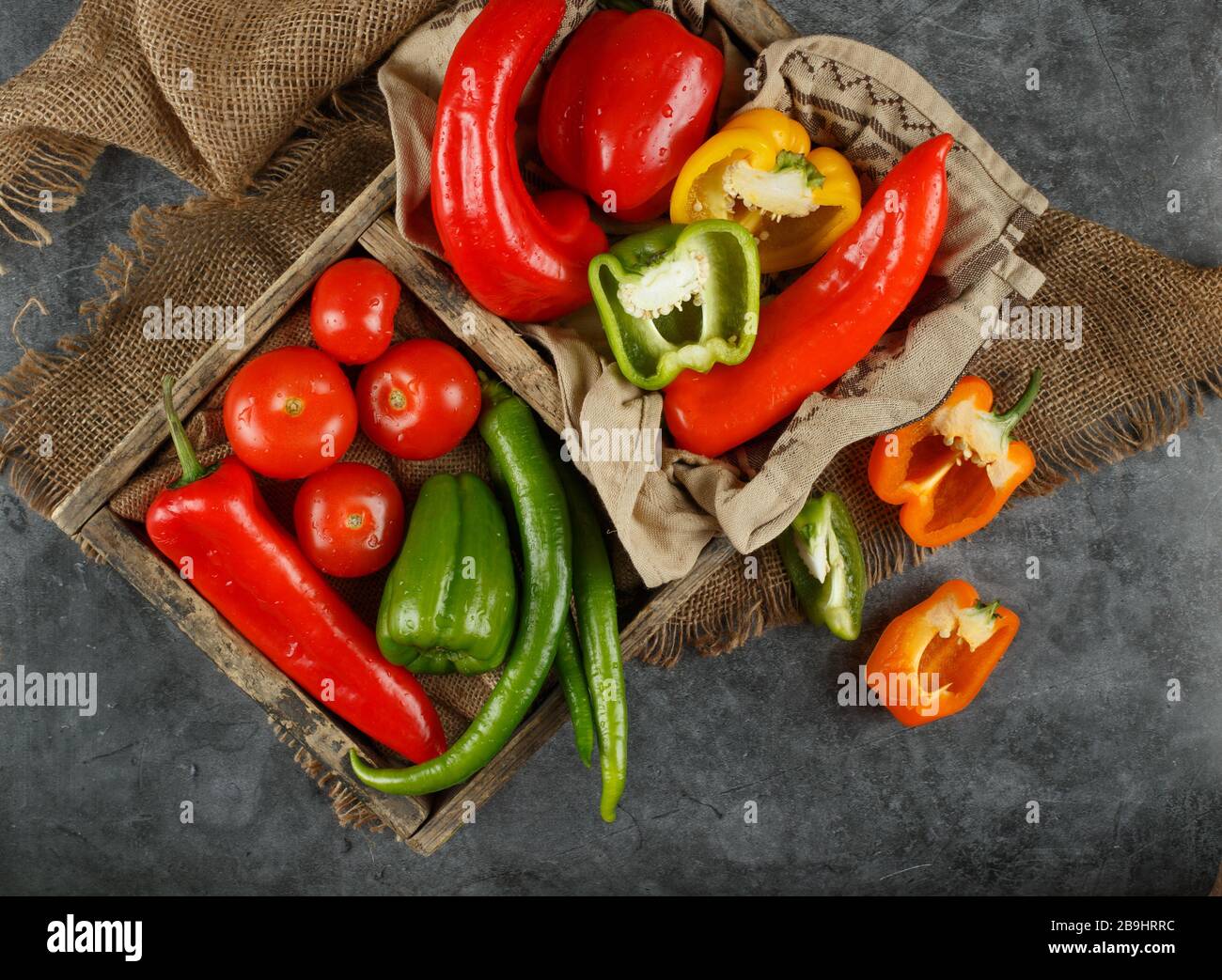 Mixed colorful peppers in a rustic container Stock Photo - Alamy