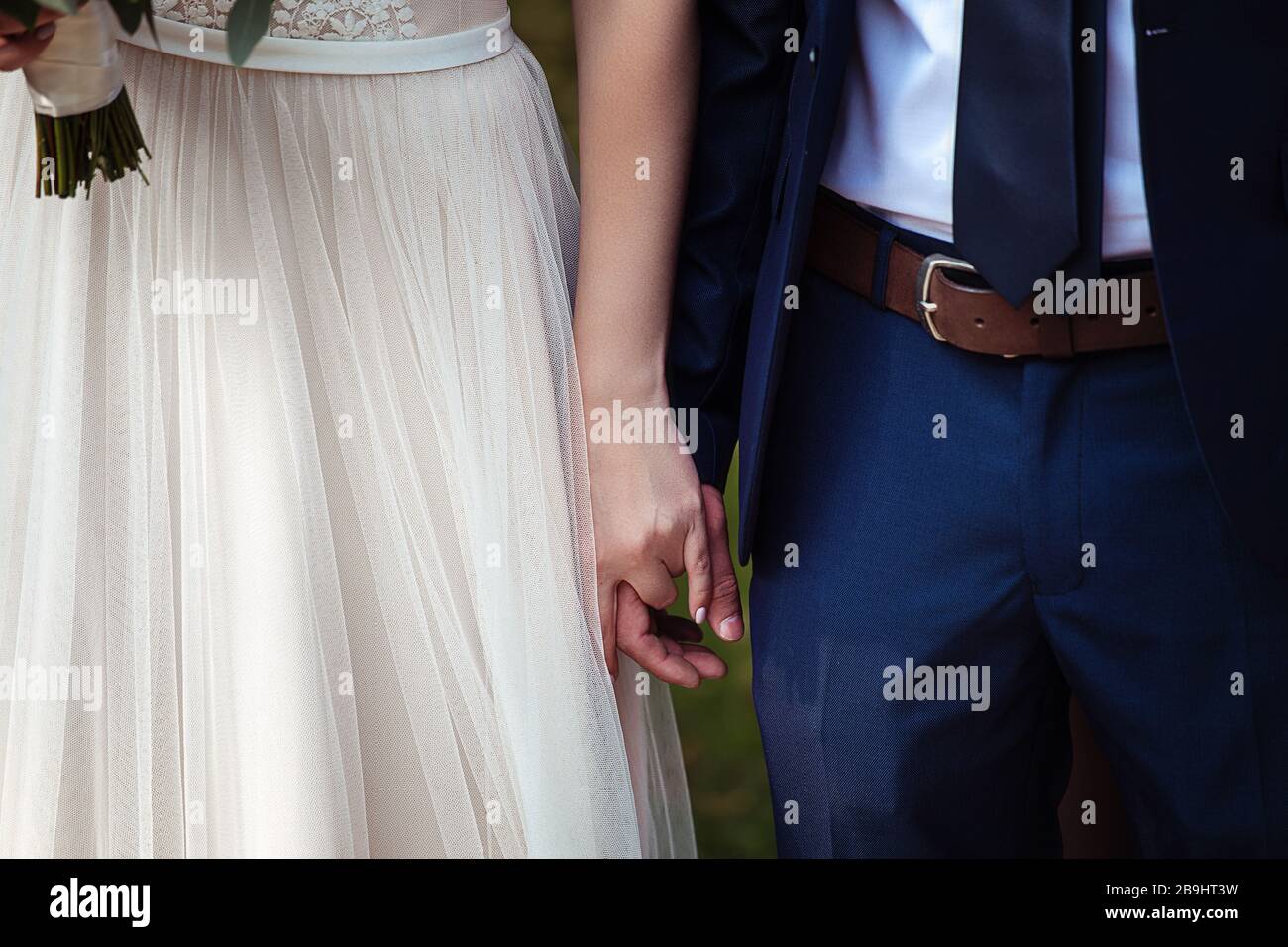 Bride and groom hold hands during wedding ceremony hi-res stock ...