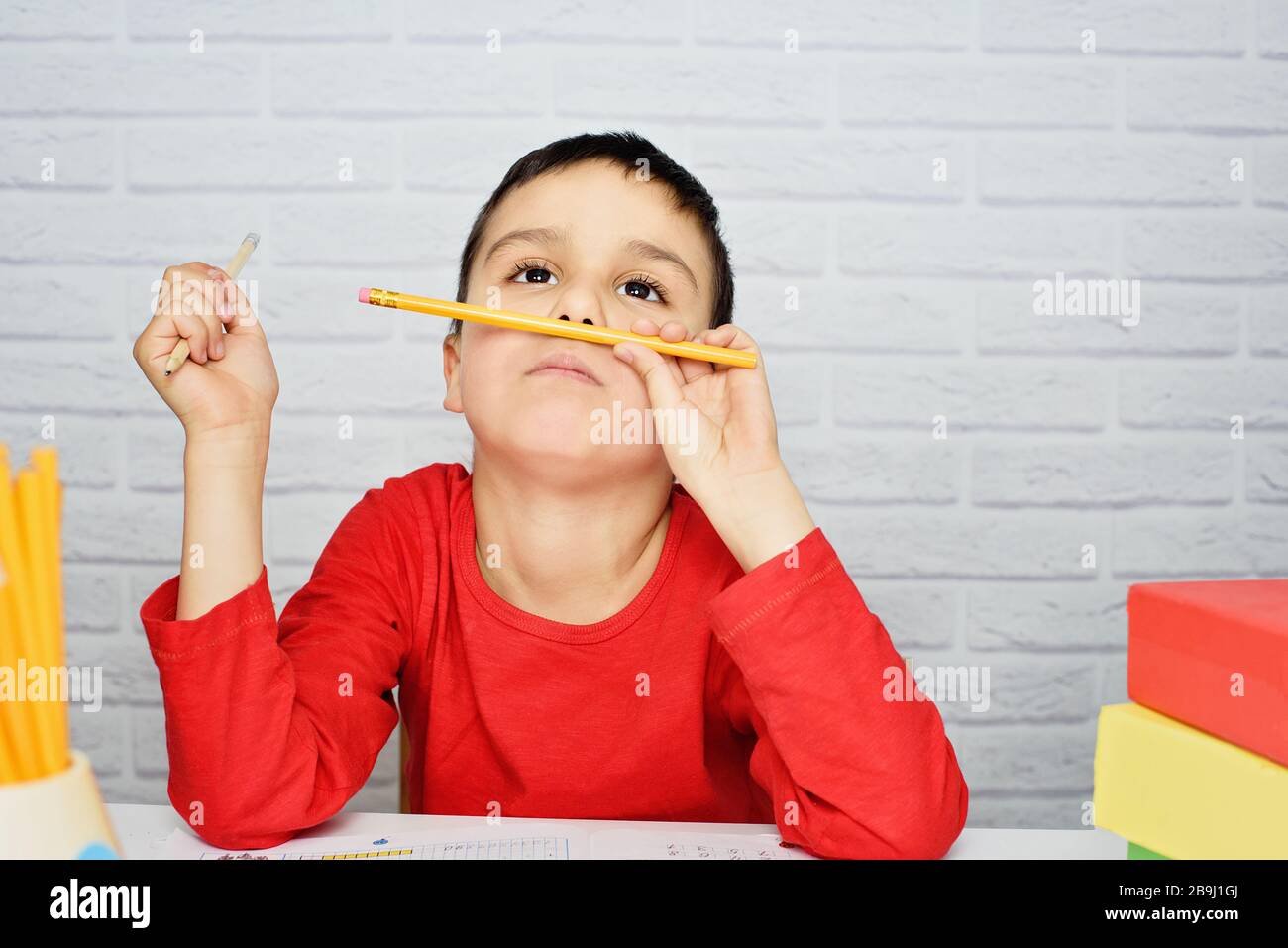 Upset boring schoolboy doing homework. Child tired of doing homework ...