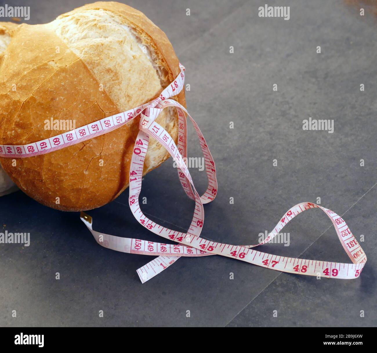 obesity and whole wheat bread, tape measure wrapped in a large bread ...