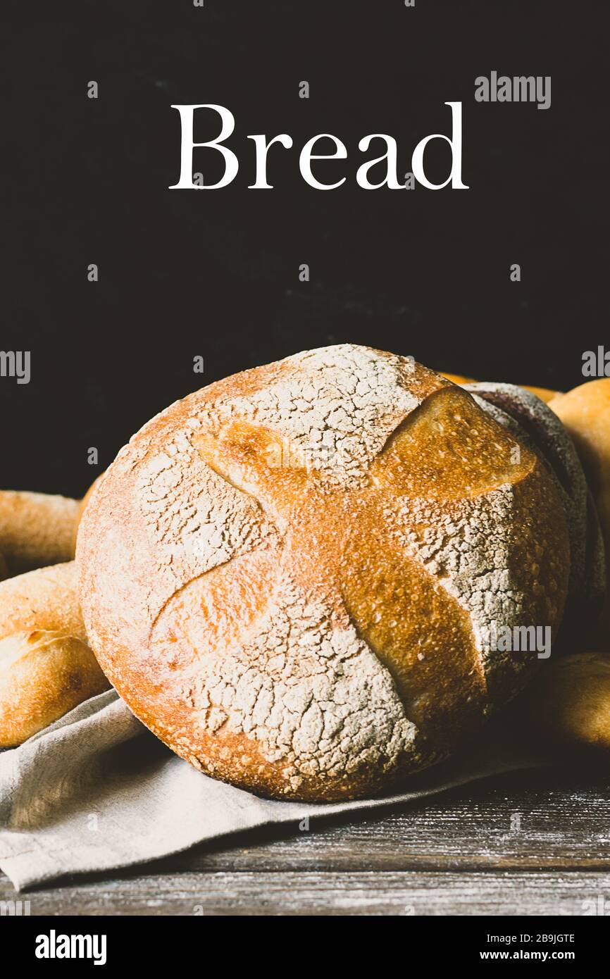 Fresh baked bread with a golden crust on dark background text bread ...