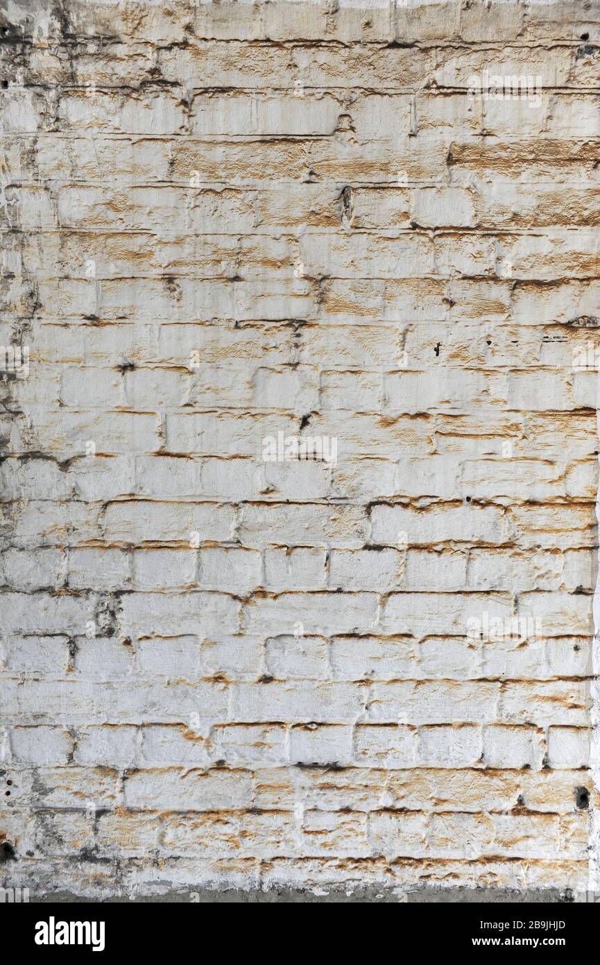 A white brick wall covered in dirty pollution gives interesting texture ...