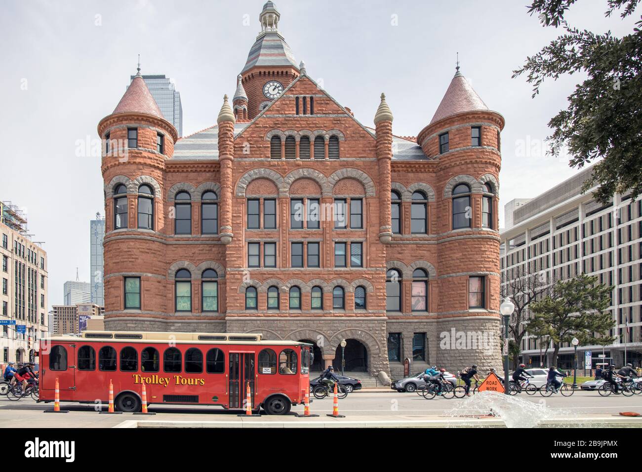 a red tour bus outside the old red museum,an old courthouse in downtown ...