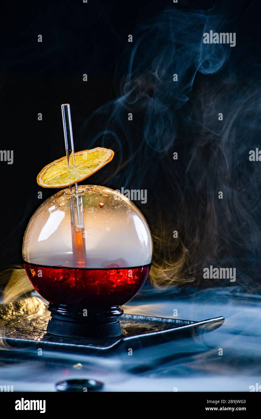 Spherical glass with smoke and alcohol. Caramelized Lemon Slices. Smoke ...