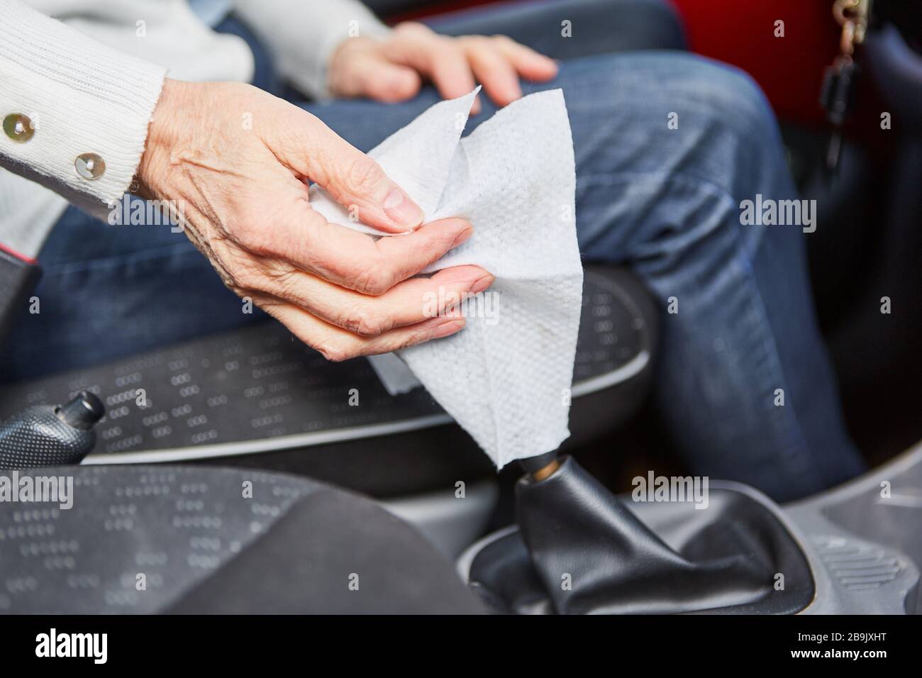 Hand disinfect the gear stick in the car with a kitchen towel Stock ...