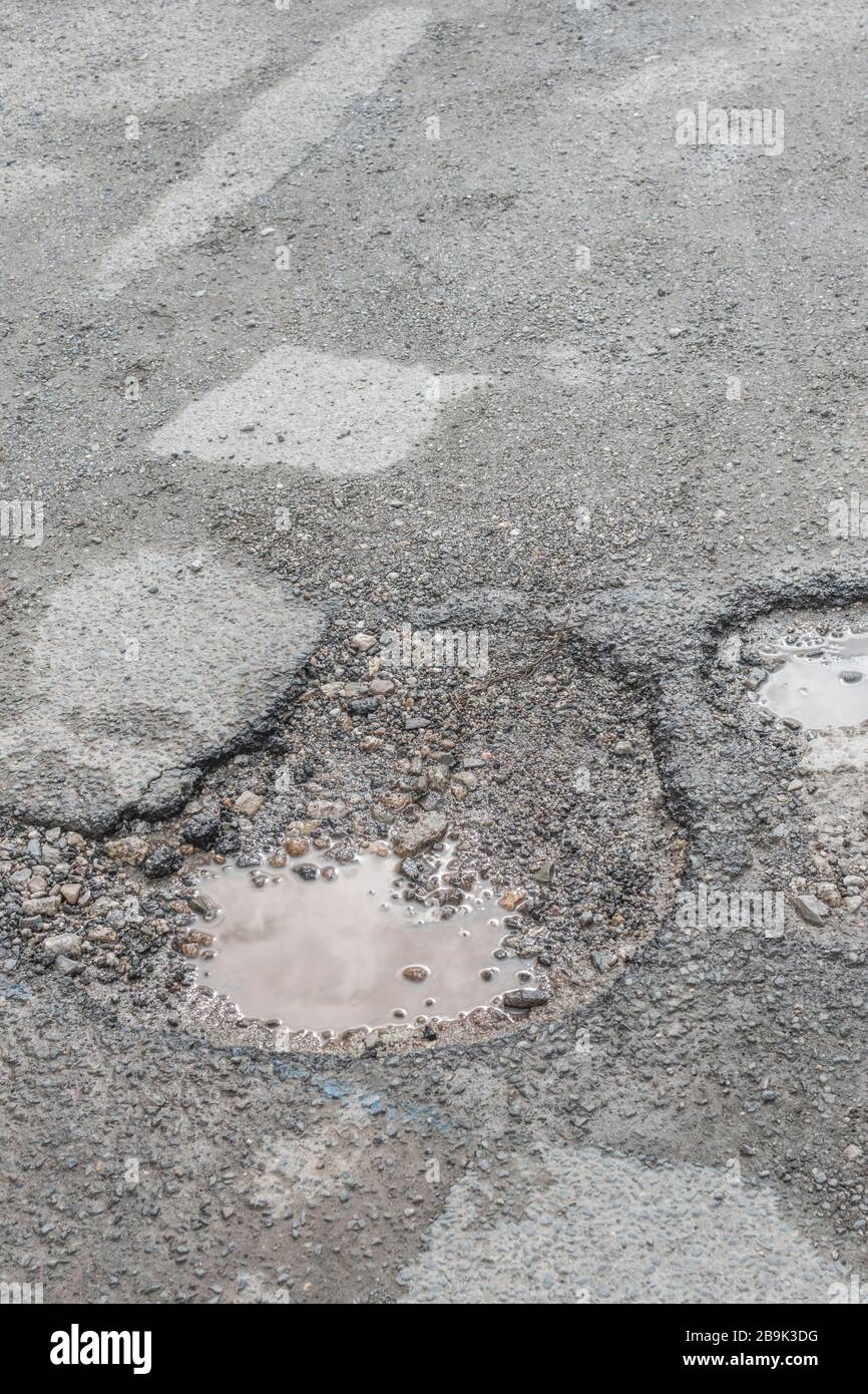 Pothole in road tarmac. For road potholes, pothole breakdowns on the ...