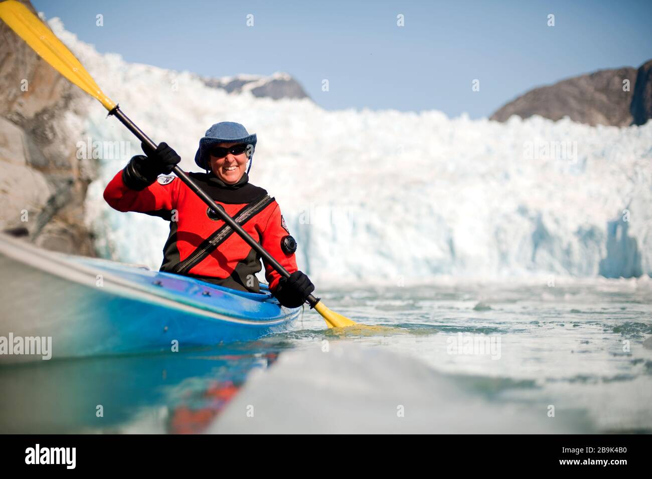 Mature woman kayaking in icy waters Stock Photo - Alamy