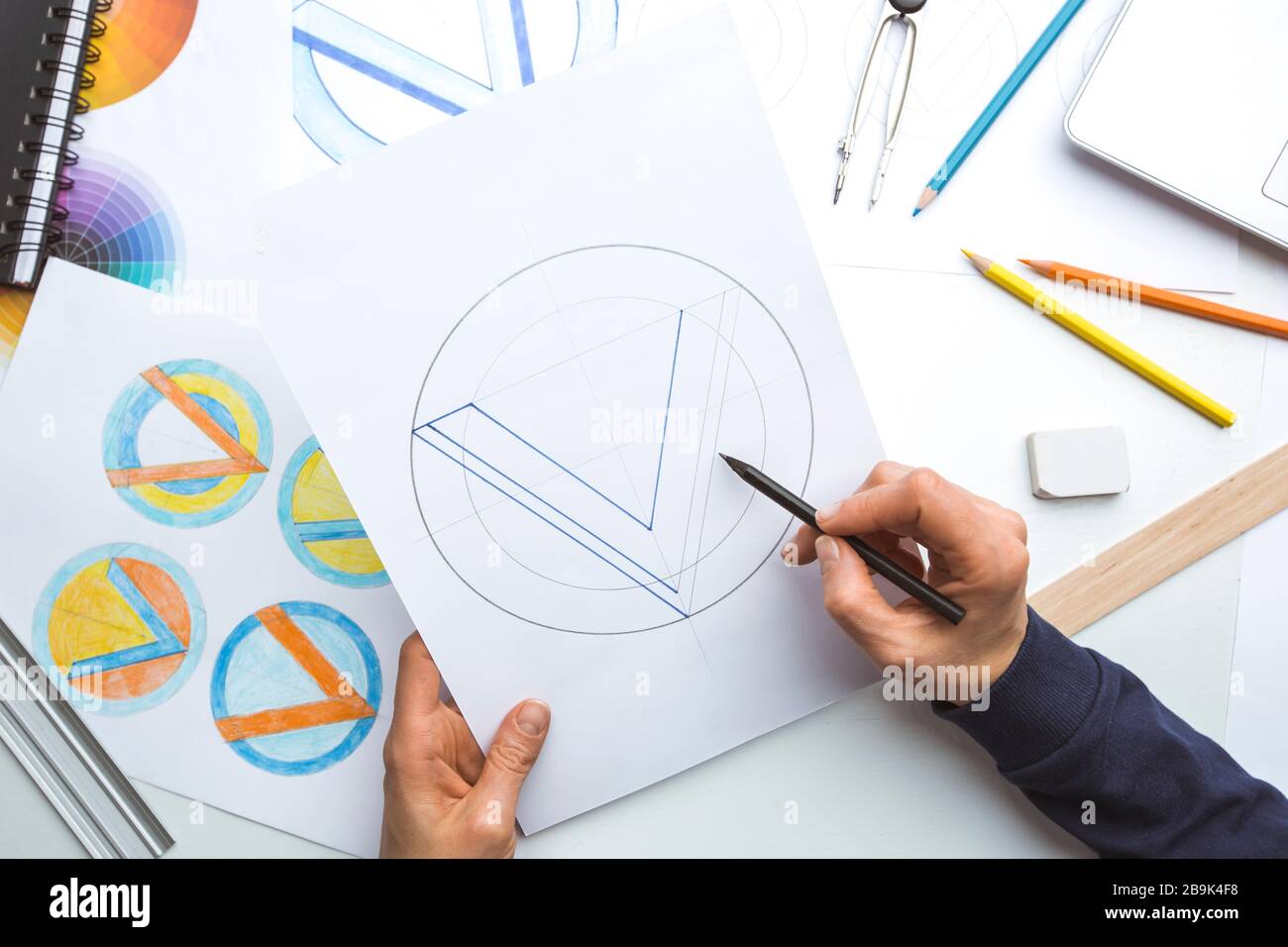 Designer draws a sketch of a brand logo Stock Photo - Alamy