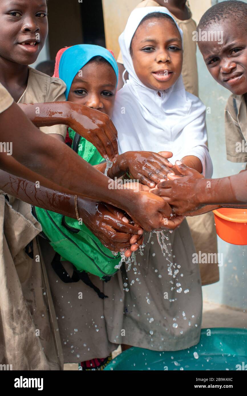 A group of African schoolchildren wash theirs hands Stock Photo - Alamy