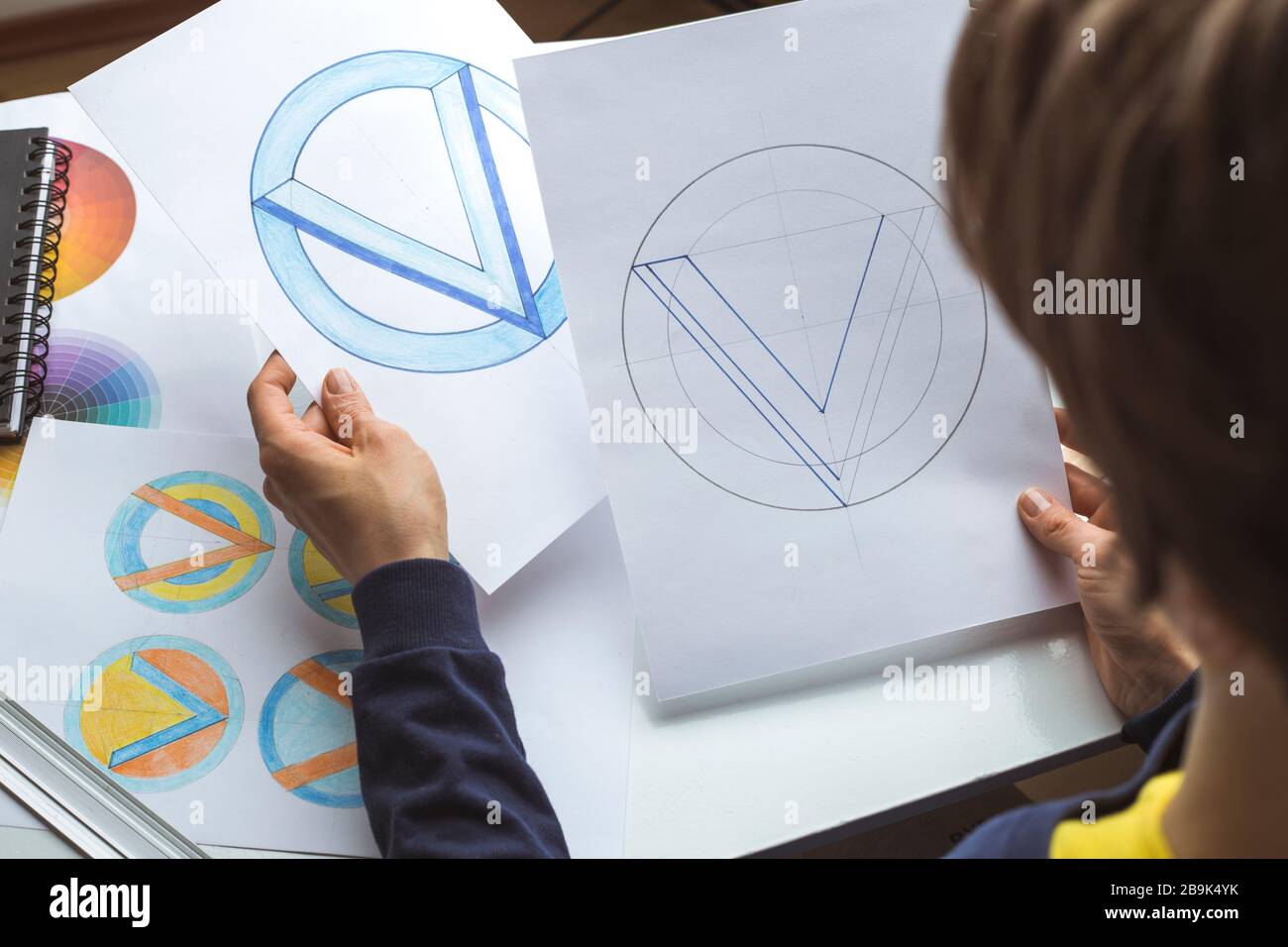 Designer draws a sketch of a brand logo Stock Photo - Alamy