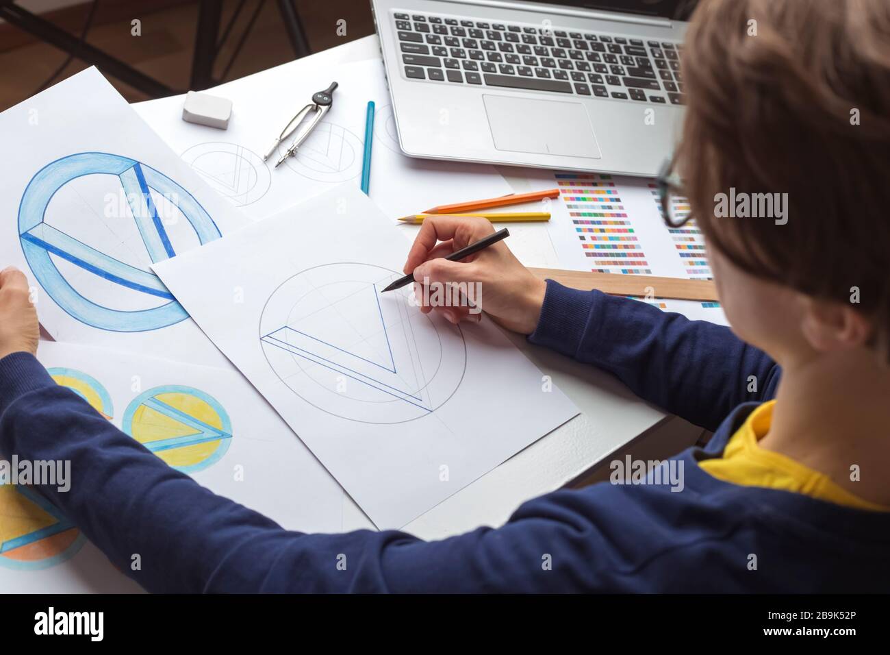 Designer draws a sketch of a brand logo Stock Photo - Alamy