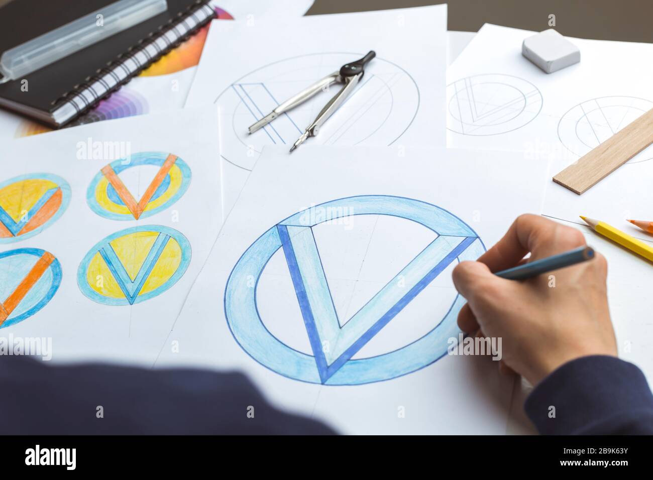 Designer draws a sketch of a brand logo Stock Photo - Alamy