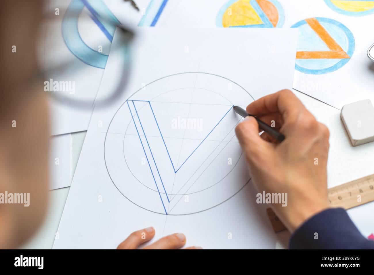 Designer draws a sketch of a brand logo Stock Photo - Alamy